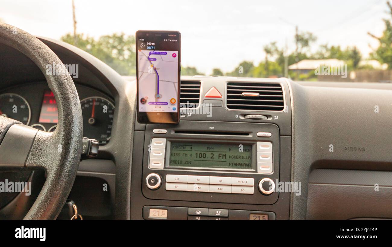 Smartphone showing Waze maps to show the way thru the city. Driver ...