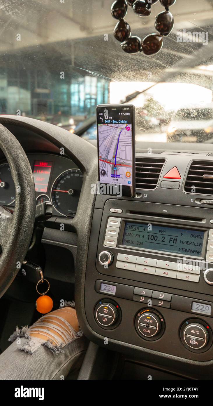 Smartphone showing Waze maps to show the way thru the city. Driver ...