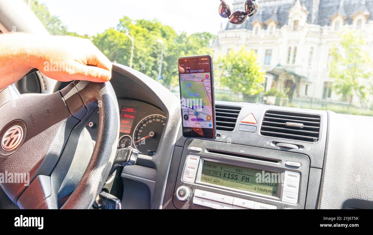 Smartphone showing Waze maps to show the way thru the city. Driver ...