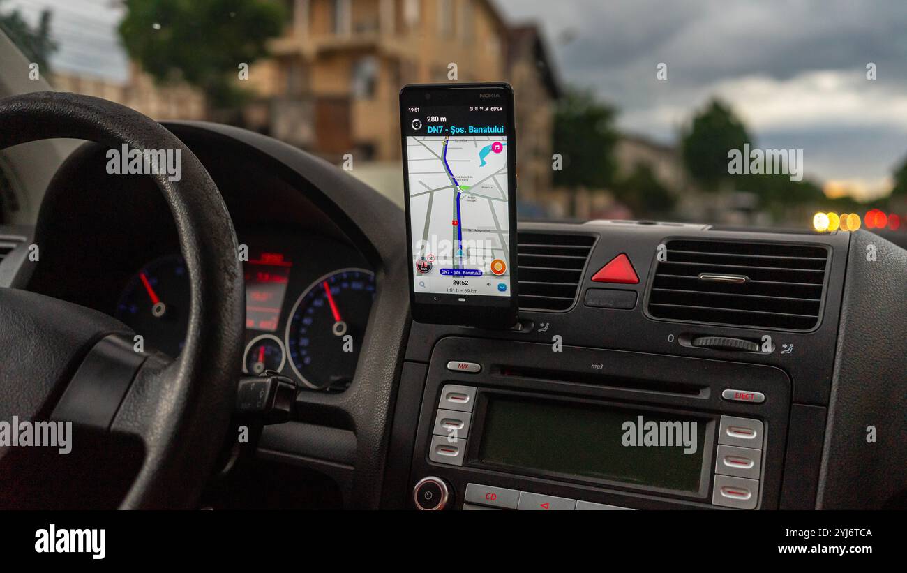Smartphone showing Waze maps to show the way thru the city. Driver ...