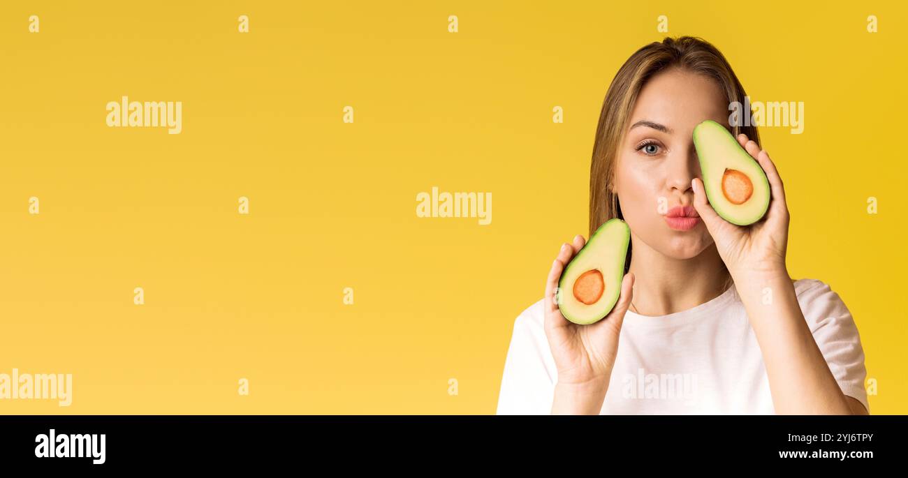 Skin Nutrition Concept. Attractive Lady Holding Two Avocado Halves Near ...
