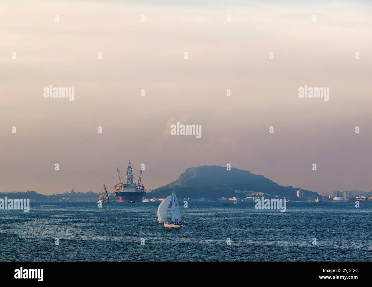 Sail boat in front of oil rig off Rio de Janeiro, Brazil with copy ...