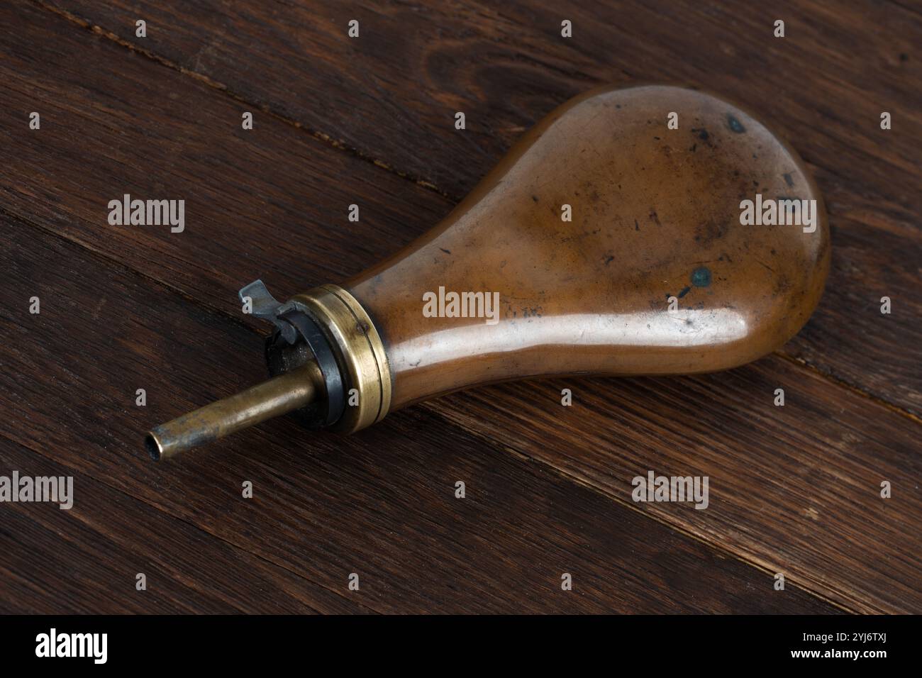 Old west gunpowder flask on wood deck background Stock Photo - Alamy