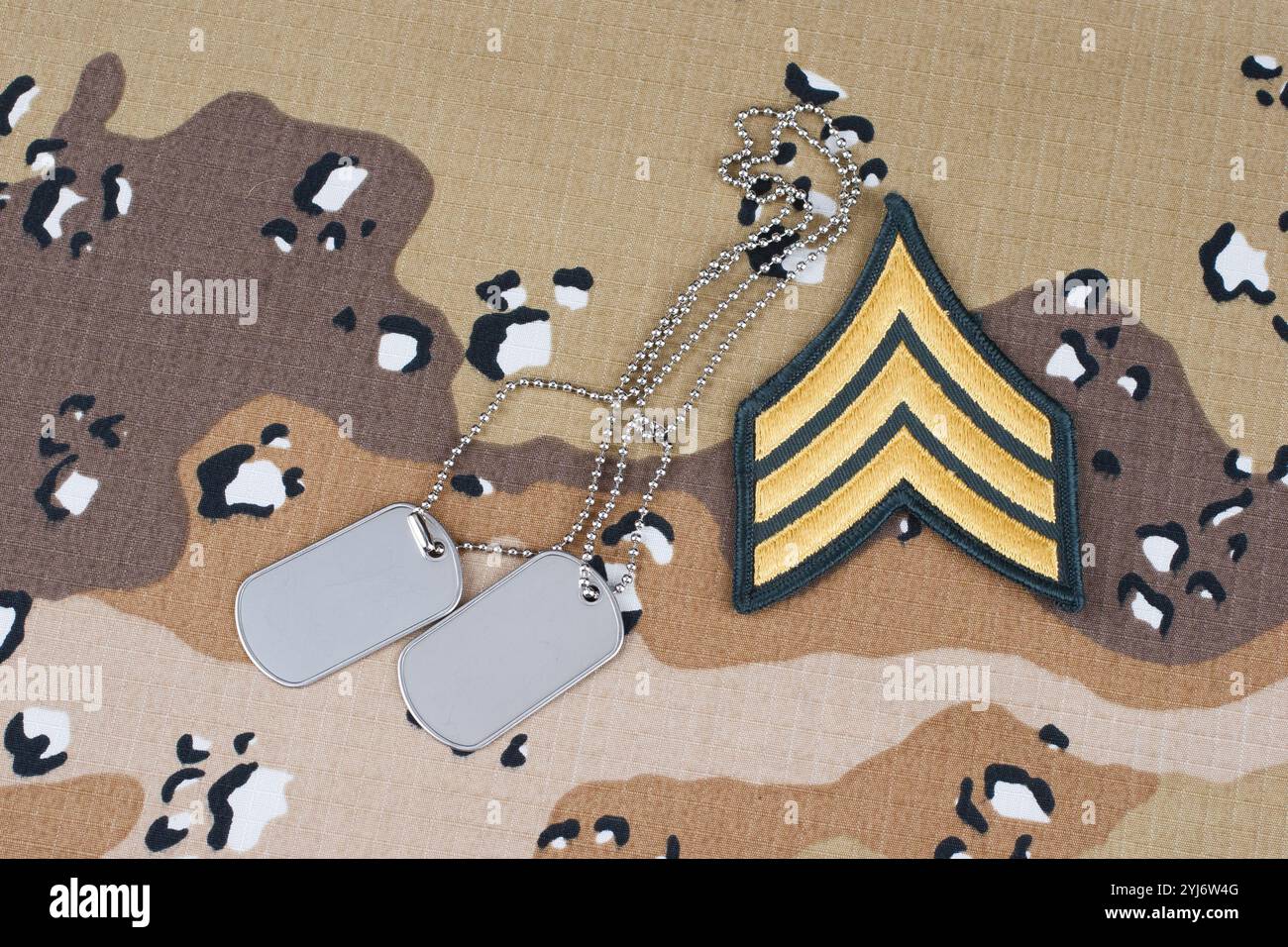 US ARMY Sergeant rank patch and dog tags on desert camouflage uniform ...