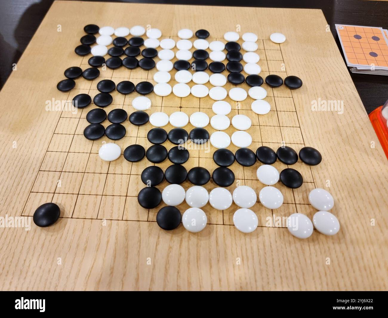 Traditional asian game go. Black and white stones lie on the game board ...