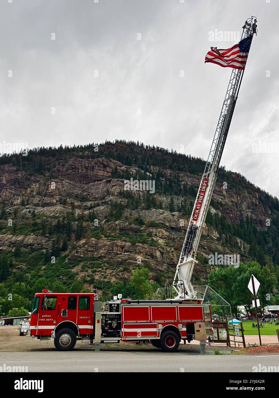The American Flag flying on a Fire Truck ladder on a summer day in the ...