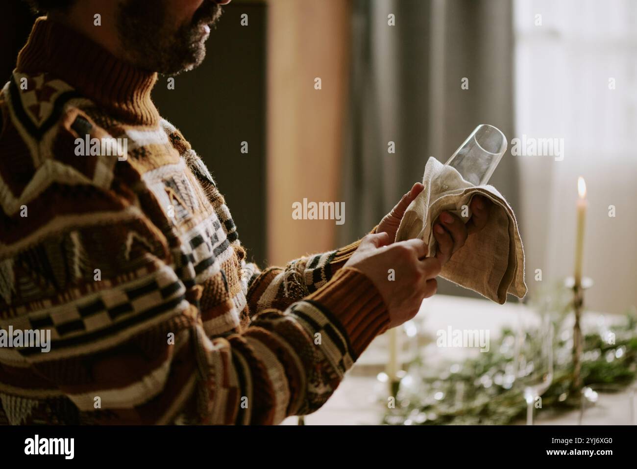 Medium close up of unrecognizable man in sweater polishing crystal ...