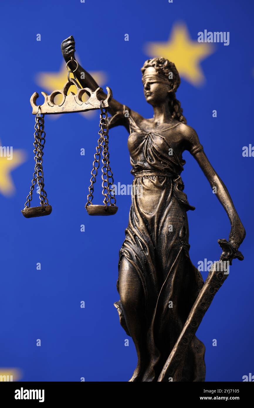 Figure of Lady Justice against European Union flag Stock Photo - Alamy