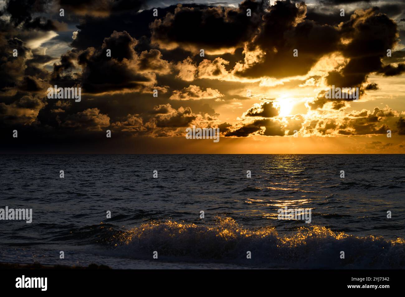 Colorful sky and sun rays. Stormy dramatic sky. Big cloud above ocean ...