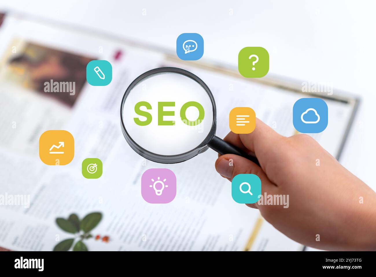 Hand holding magnifying glass examining book with SEO text, conceptual ...