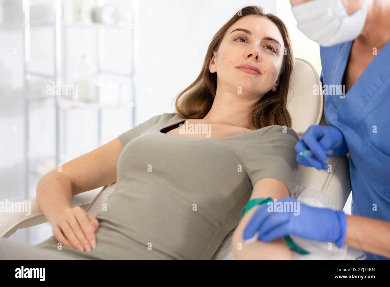 Elderly doctor drawing blood from young patient Stock Photo - Alamy