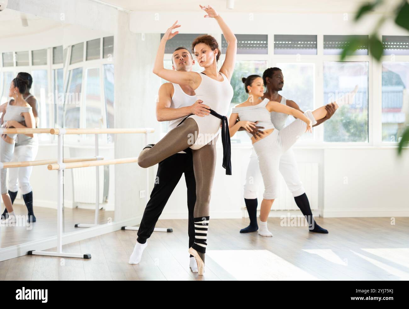 Man and girl woman together arabesque position of ballet during ...