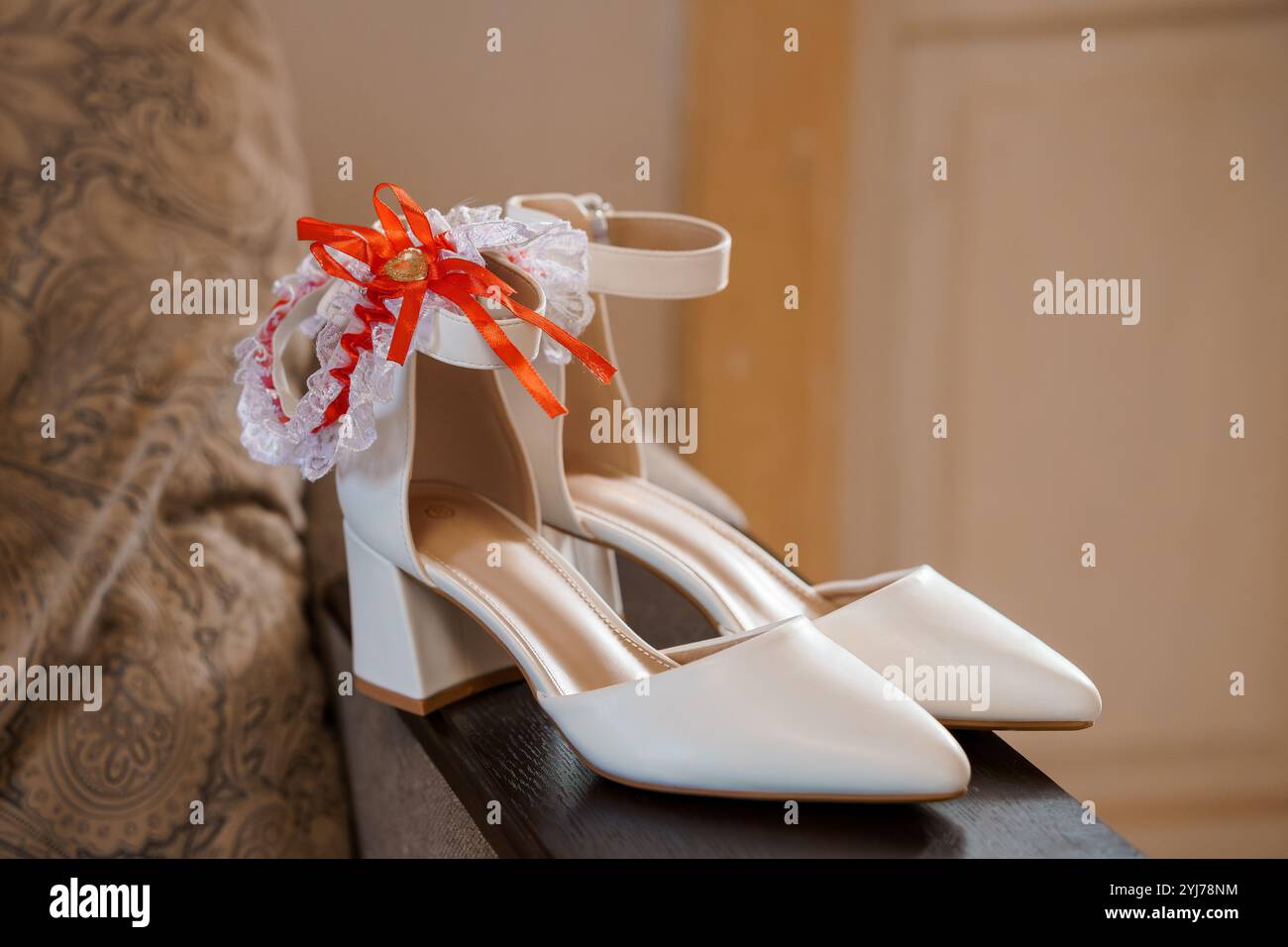 Elegant White Wedding Shoes with Decorative Garter and Ribbon Accents ...