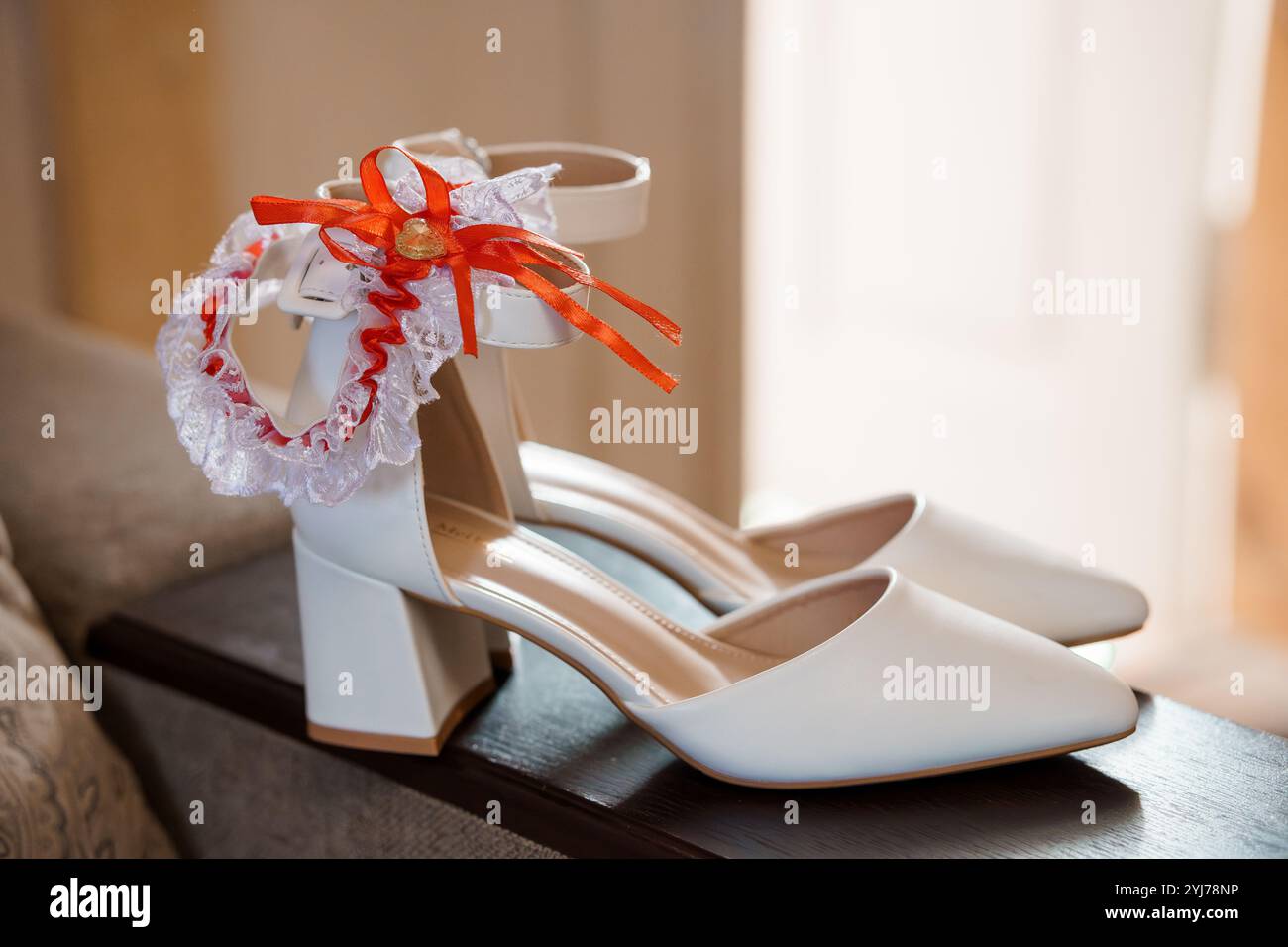 Elegantly Styled White Bridal Heels with Decorative Garter Stock Photo ...