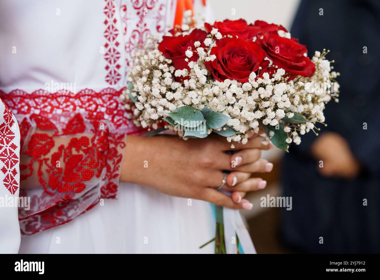 Elegant Bride Holding a Charming Bouquet of Red Roses and Baby's Breath Stock Photo - Alamy