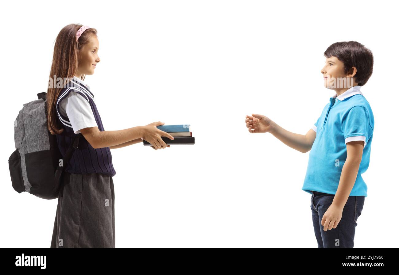 Schoolgirl giving books to a boy isolated on white background Stock ...