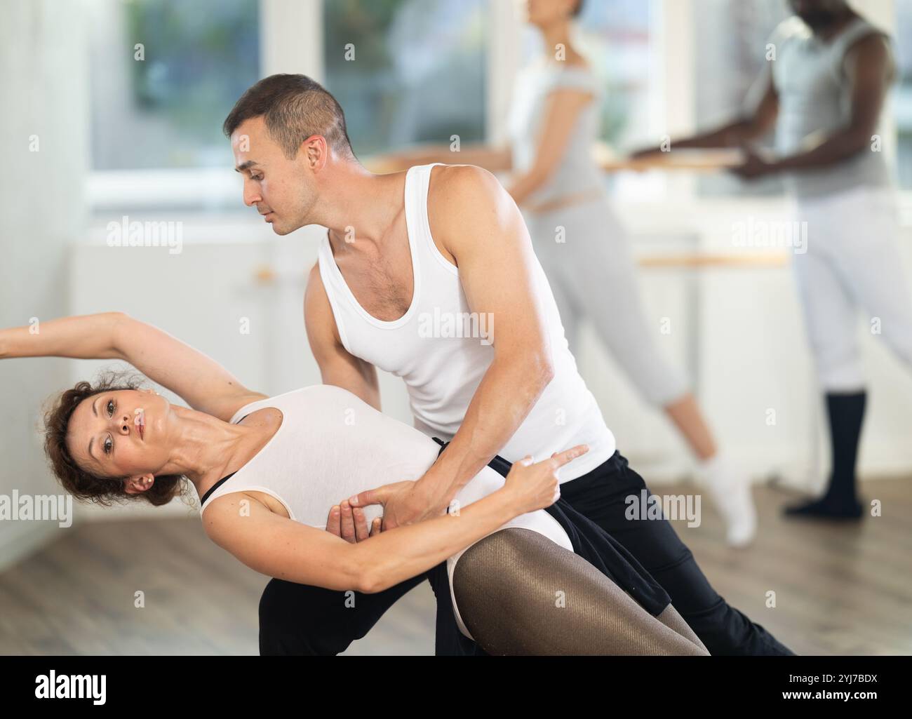 Man and girl woman together arabesque position of ballet during ...