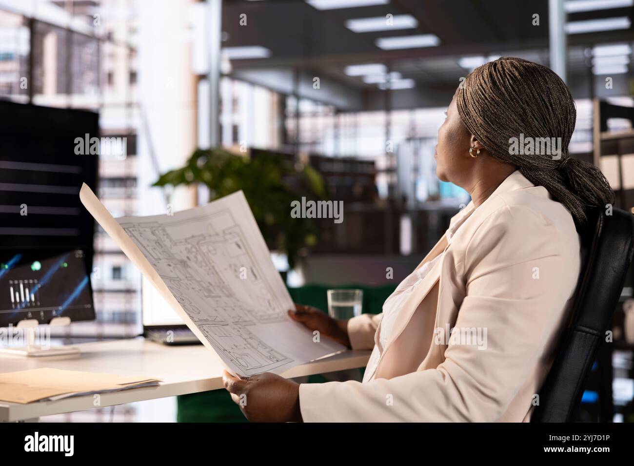 Architect in office creating detailed drawings and specifications for ...