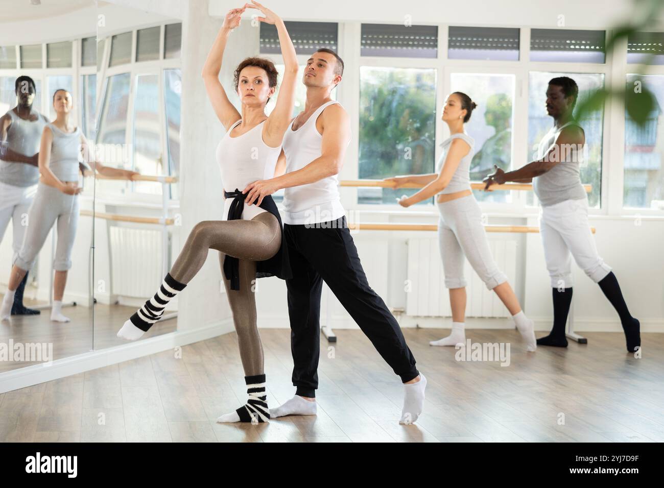 Ballet partners mastering paired technique during group class Stock ...