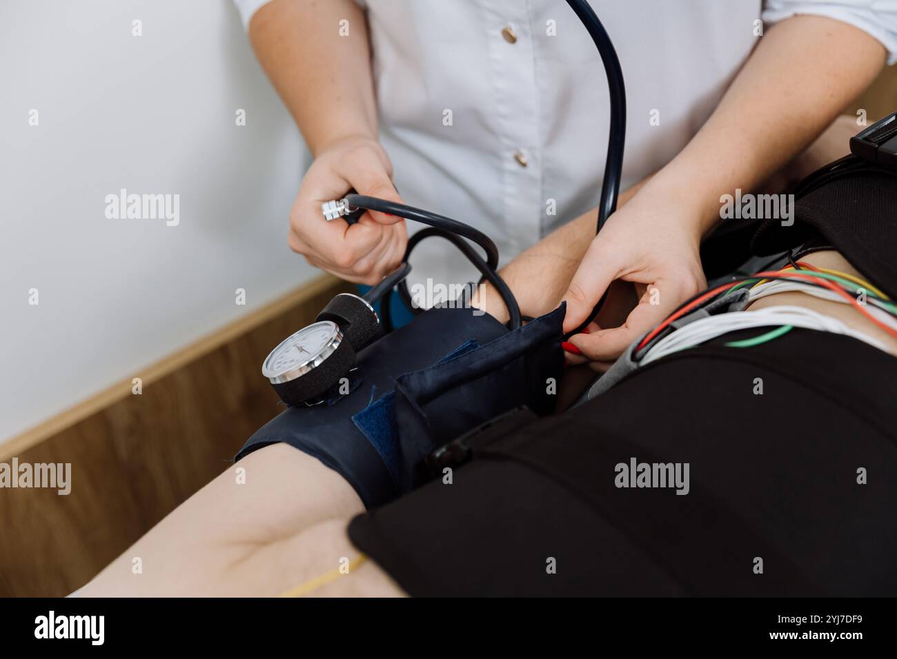 Healthcare worker checking blood pressure of a patient during a ...