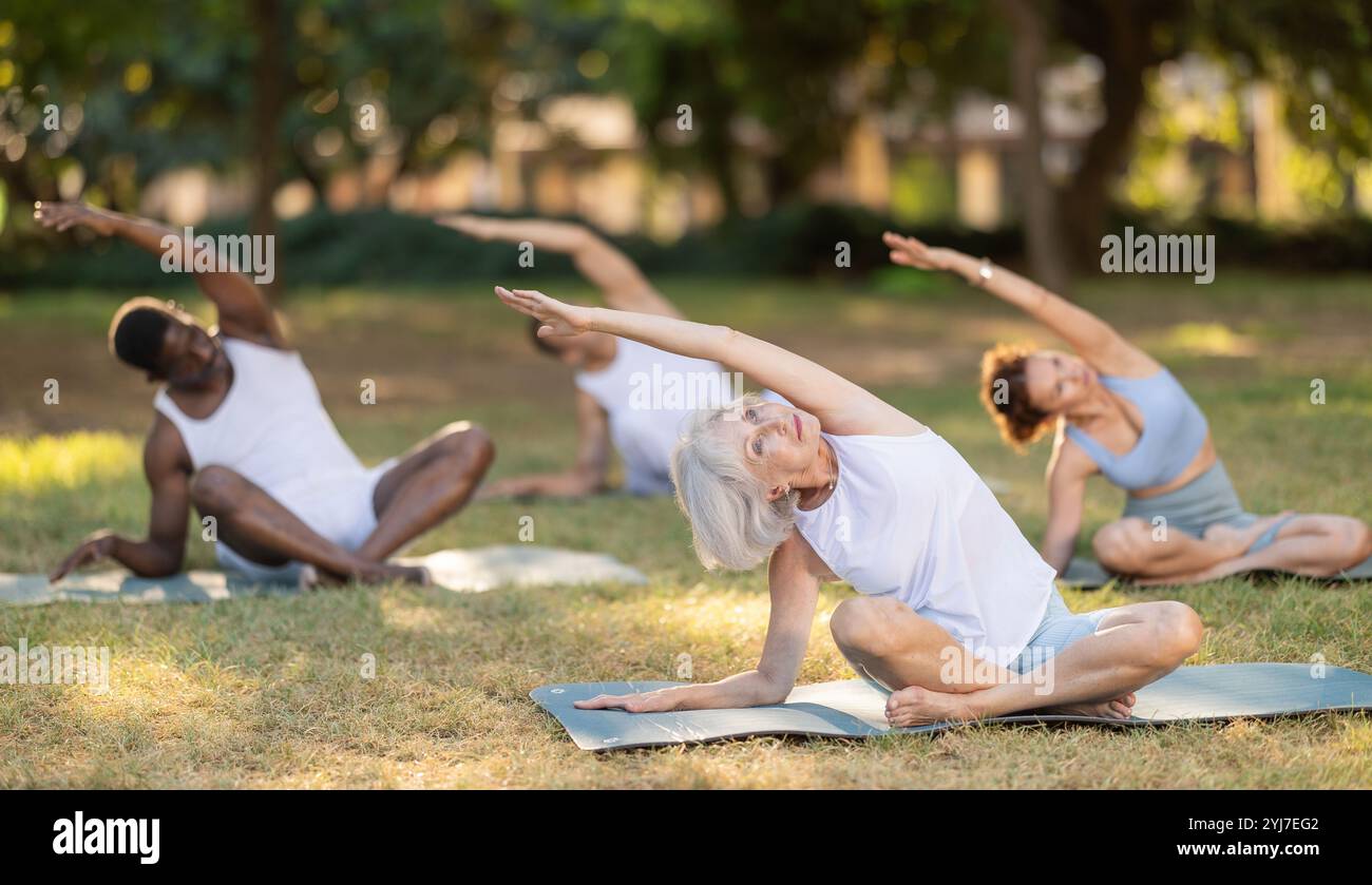 Group of athletic people of different nationalities exercise together ...