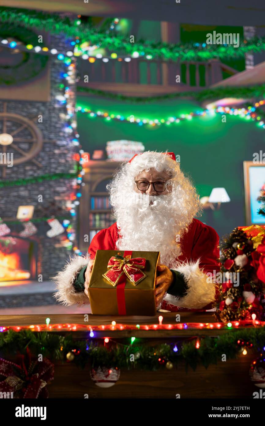 Saint Nicholas prepares a festive gift box by the fire. The North Pole ...