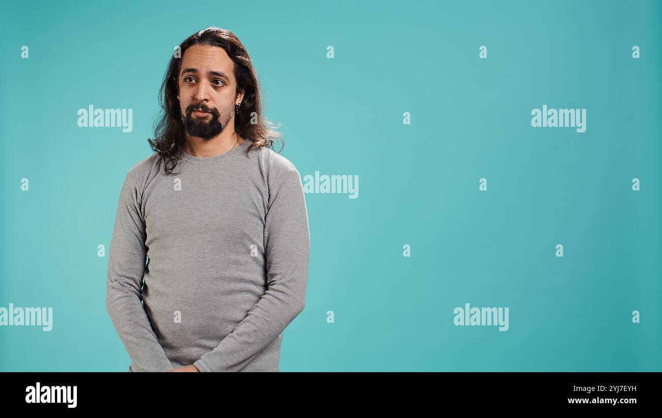 Portrait of spiteful man making exaggerated silly faces, mimicking ...