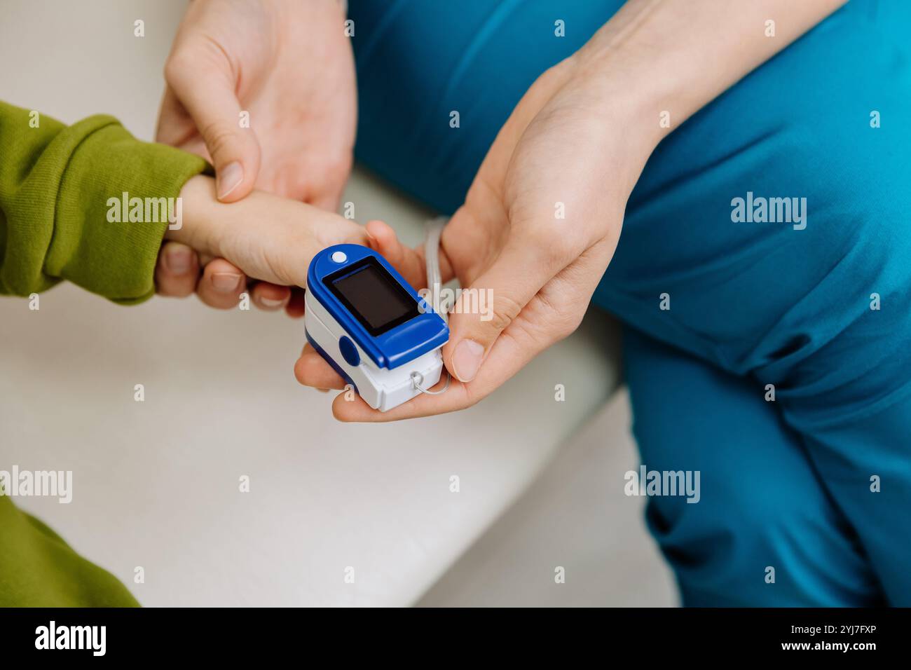 Healthcare professional checking childs vitals with a pulse oximeter for accurate monitoring ...
