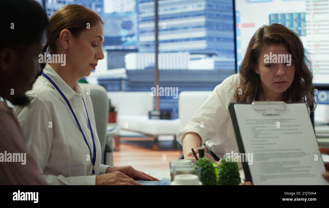 Financial expert showing statistics data on papers in a conference room ...