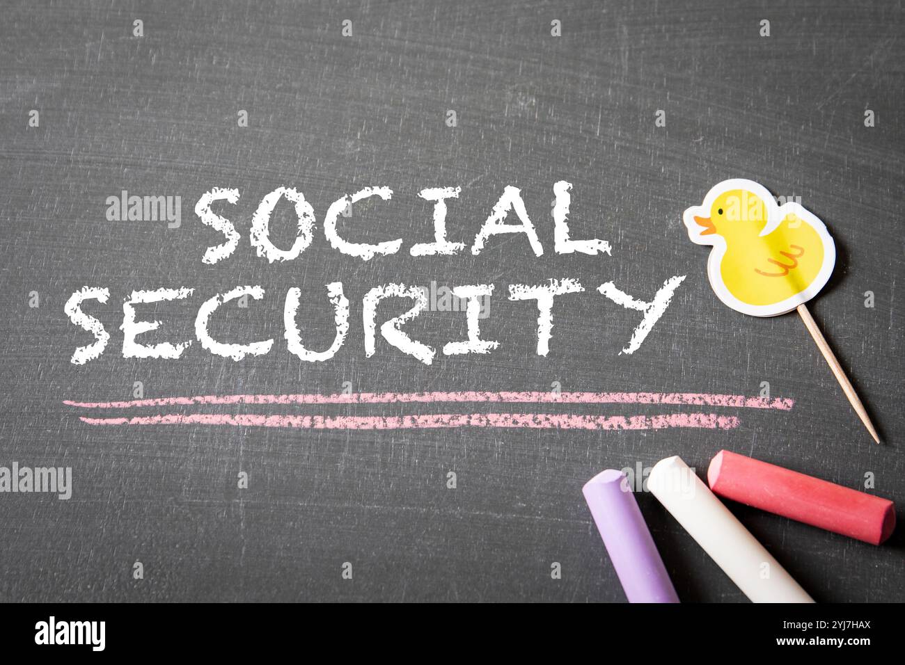 SOCIAL SECURITY Concept. Text and colored pieces of chalk on a dark ...