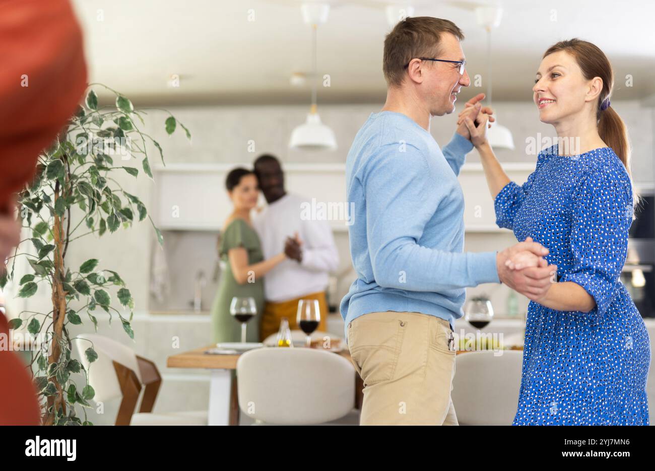 Men and women of different nationalities having fun dancing slow dance ...