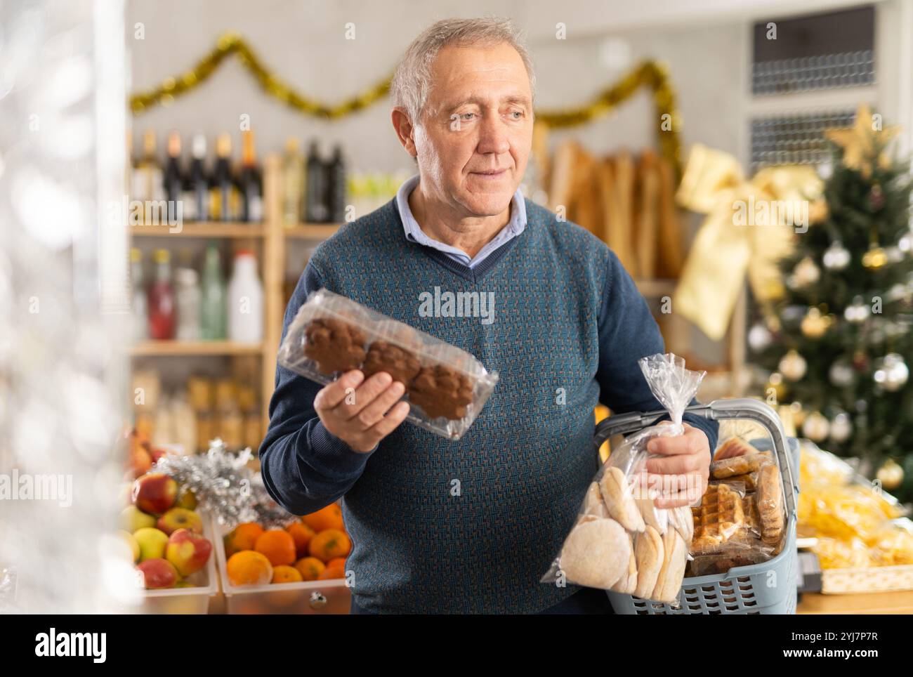 Elderly man choosing cookies at grocery store Stock Photo - Alamy