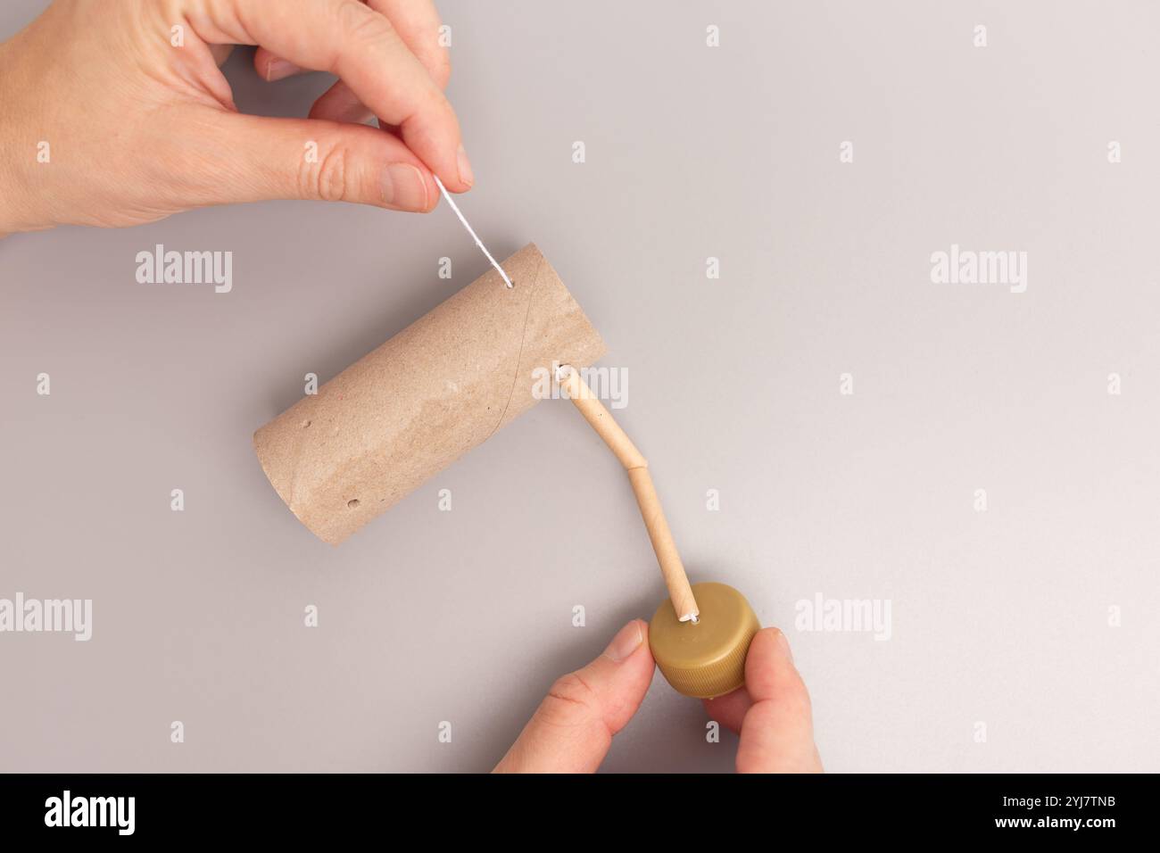 a DIY reindeer puppet leg being assembled using a cardboard tube ...