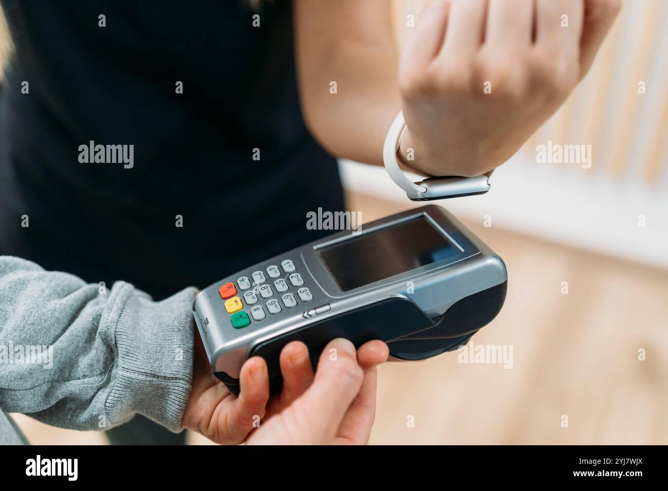 Customer paying with smartwatch in a retail store Stock Photo - Alamy