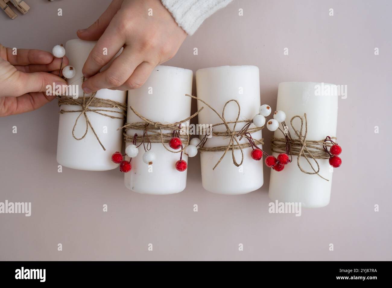 DIY process of woman making Christmas arrangement of advent candle calendar four weeks. Series ...