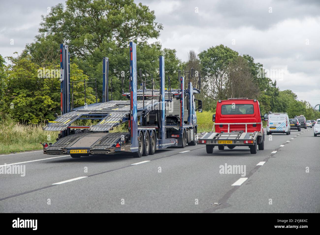 London, UK- June 30, 2023: Small and large car transporter trucks on M4 ...