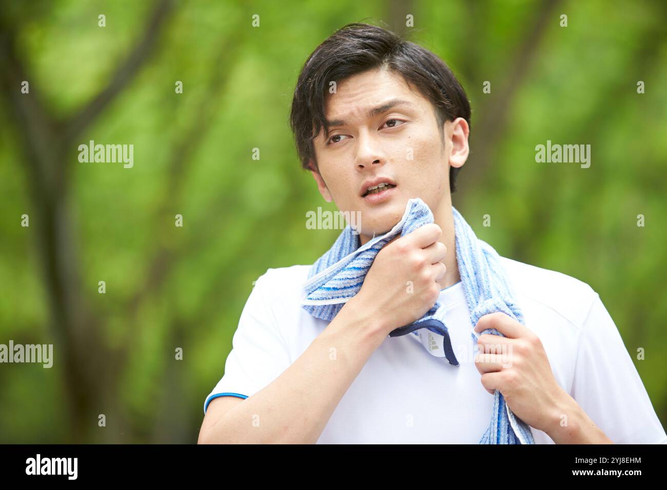 Man wiping sweat with towel Stock Photo - Alamy