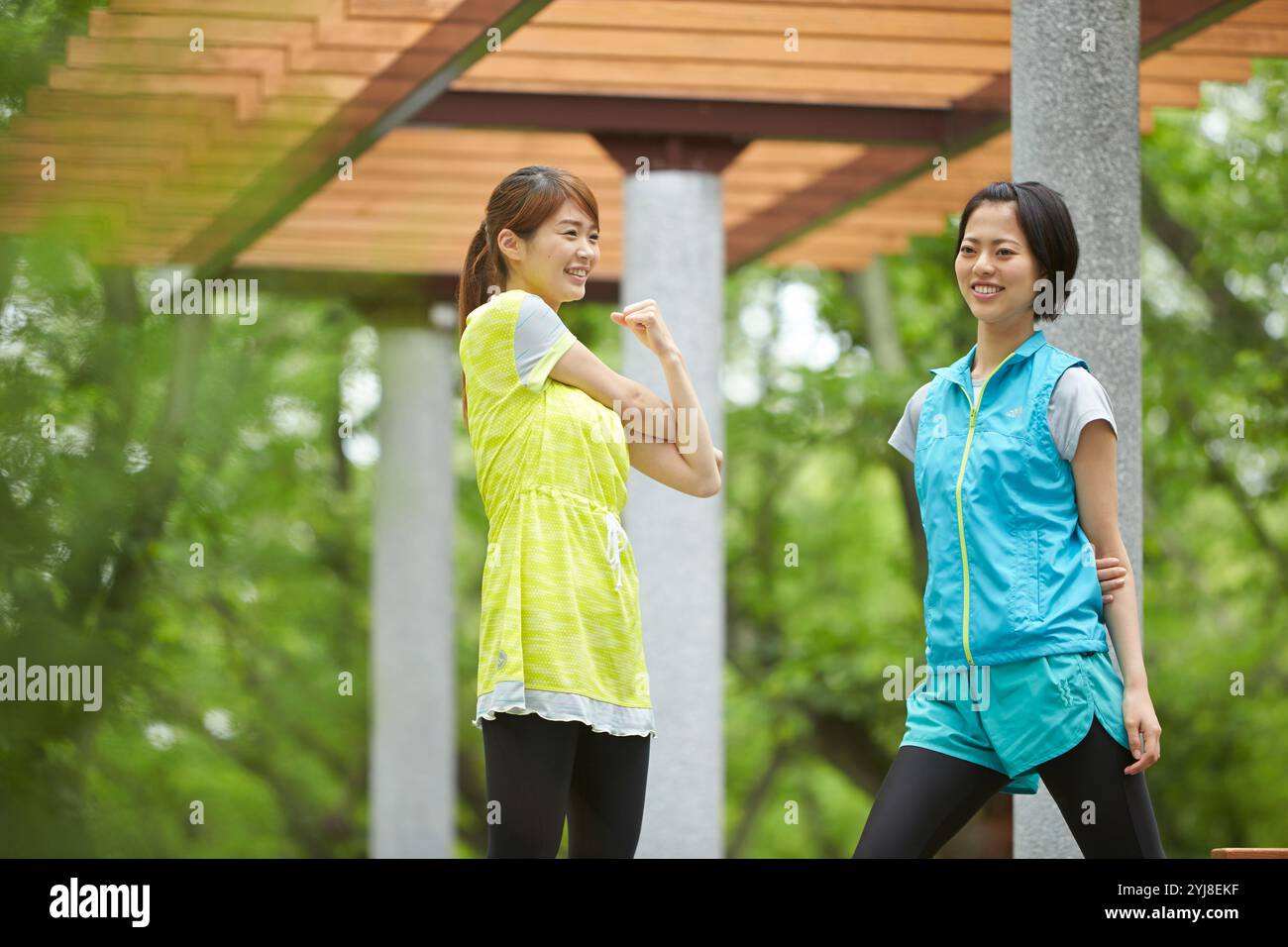 Two women stretching before running Stock Photo - Alamy