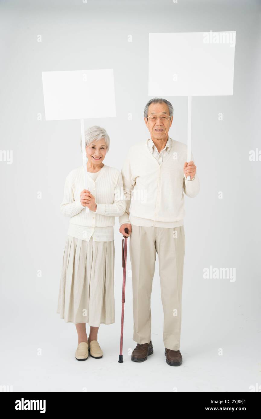 Elderly couple with placards Stock Photo - Alamy
