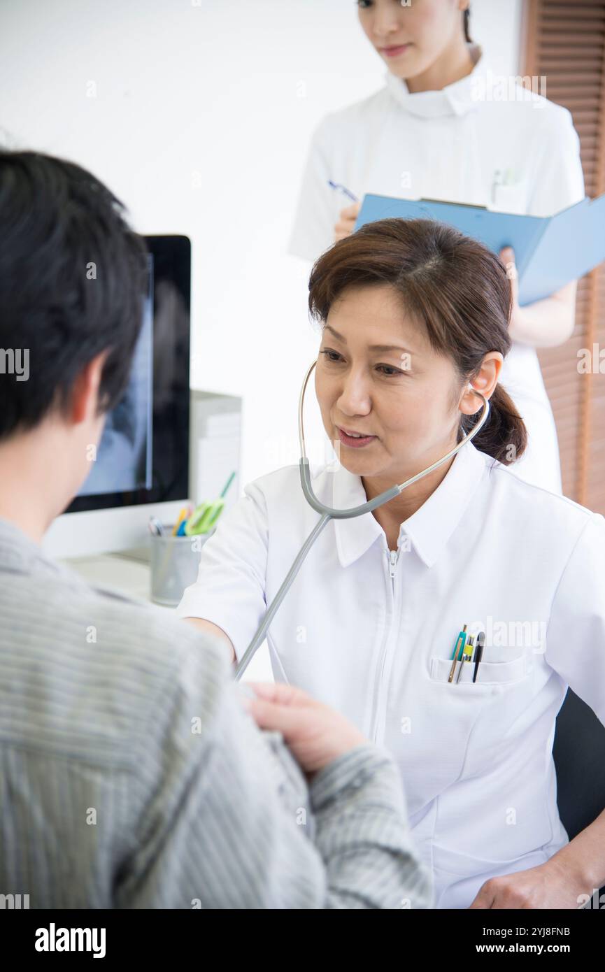 Male patients and nurses visiting female doctors Stock Photo - Alamy