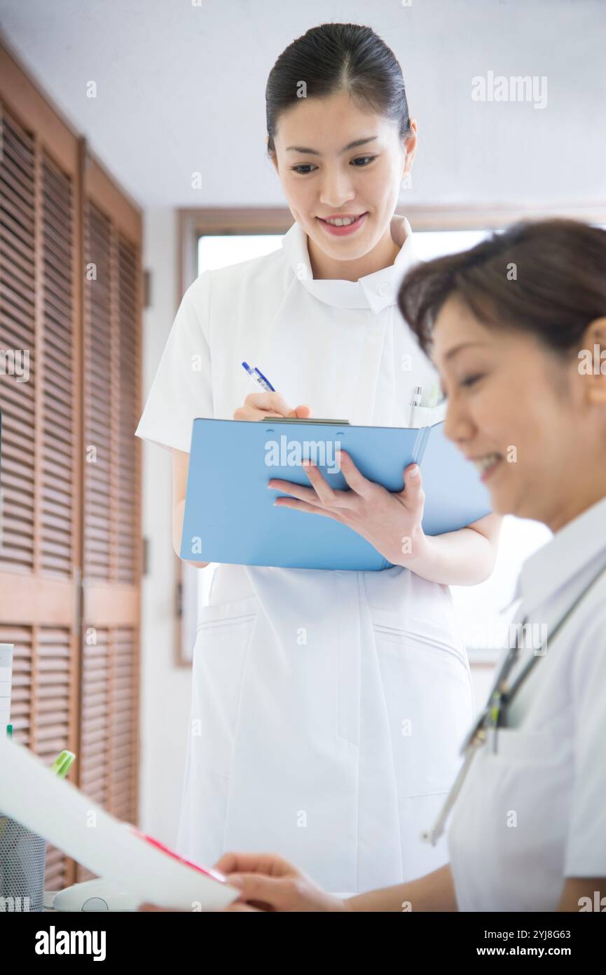 Female doctor and nurse in examination room Stock Photo - Alamy