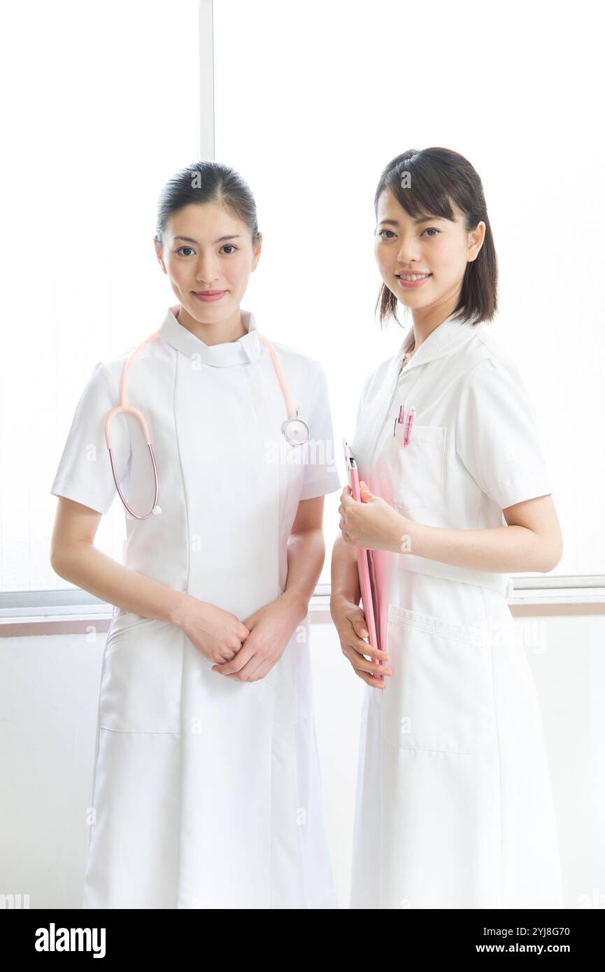 Two nurses in white coats Stock Photo - Alamy