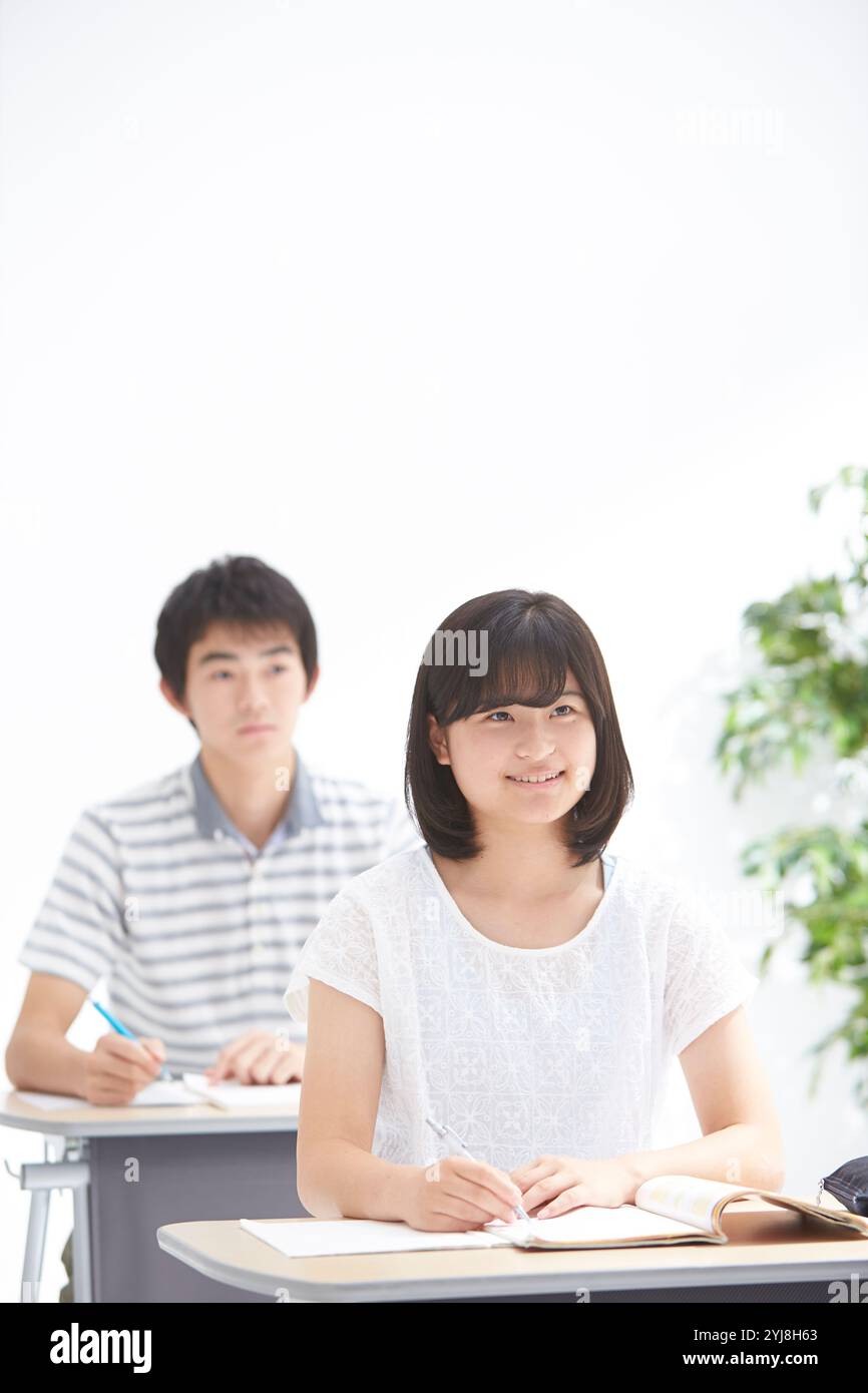 Male and female high school students in class at a cram school Stock ...