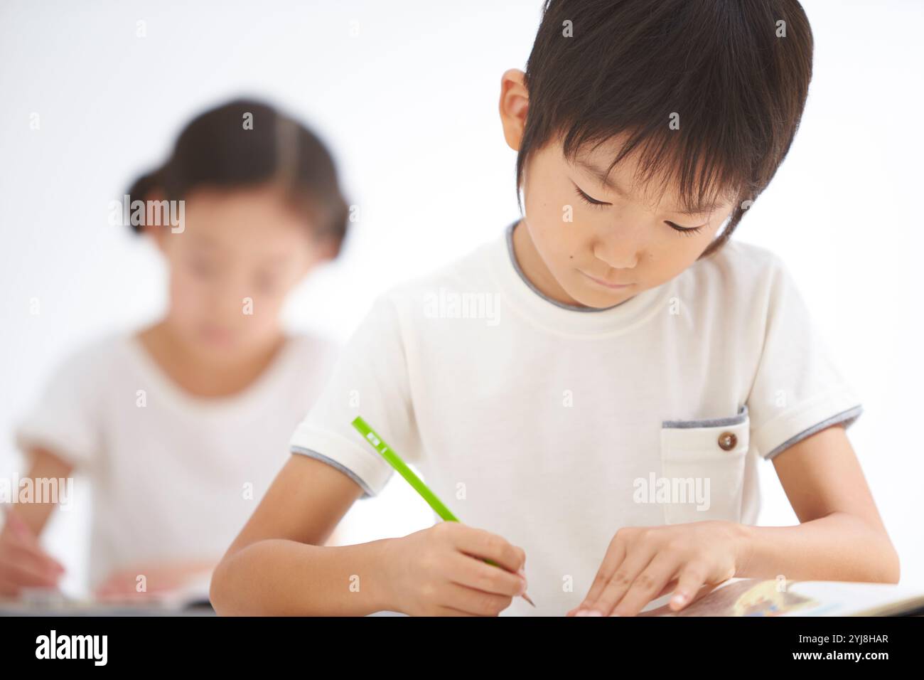 Male and female lower primary school pupils in class Stock Photo - Alamy