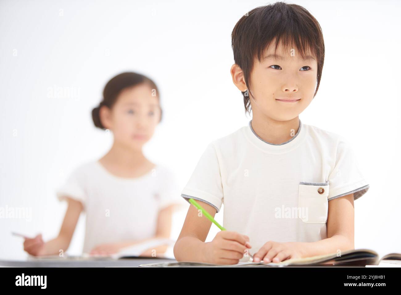 Male and female lower primary school pupils in class Stock Photo - Alamy