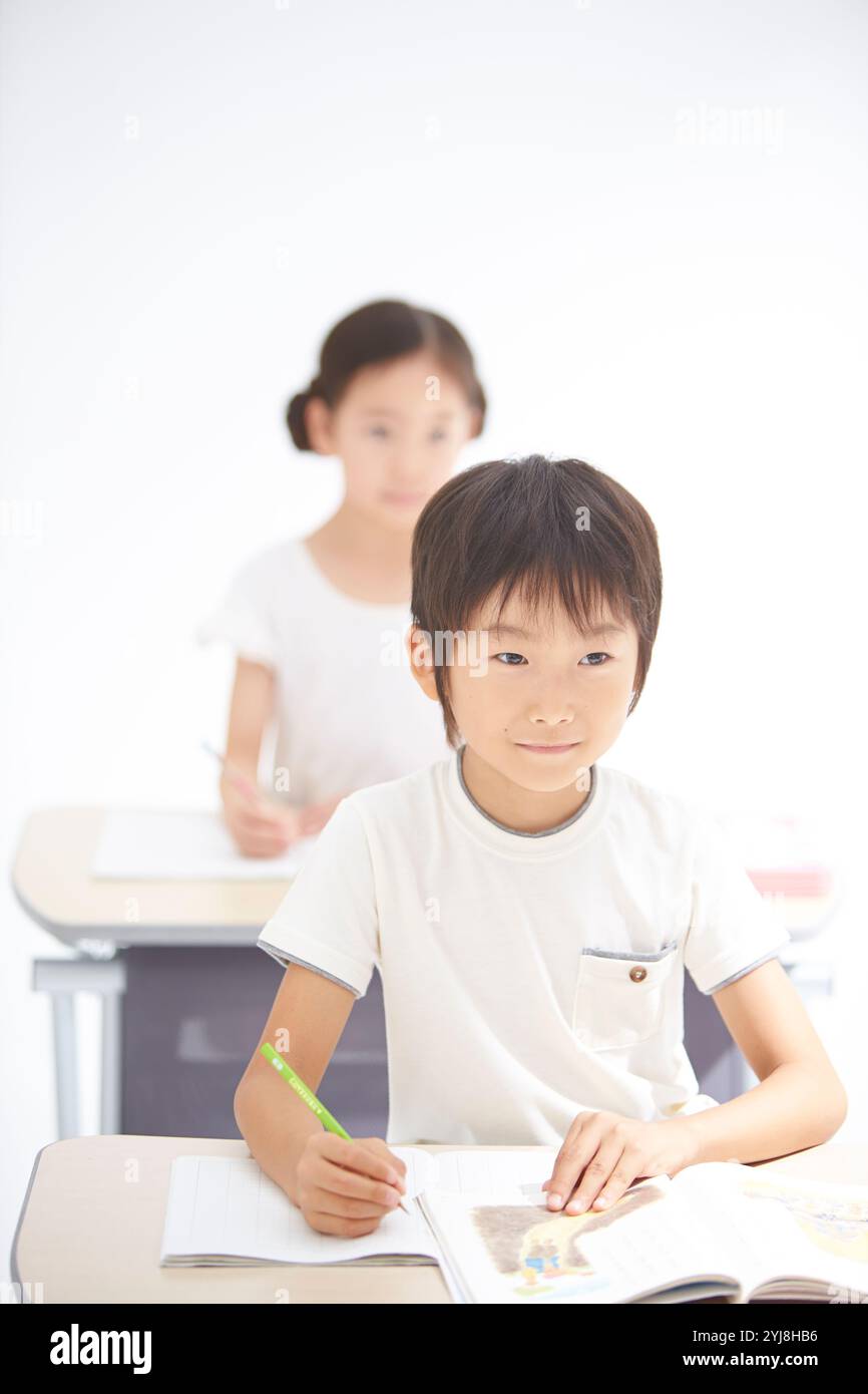 Male and female lower primary school pupils in class Stock Photo - Alamy