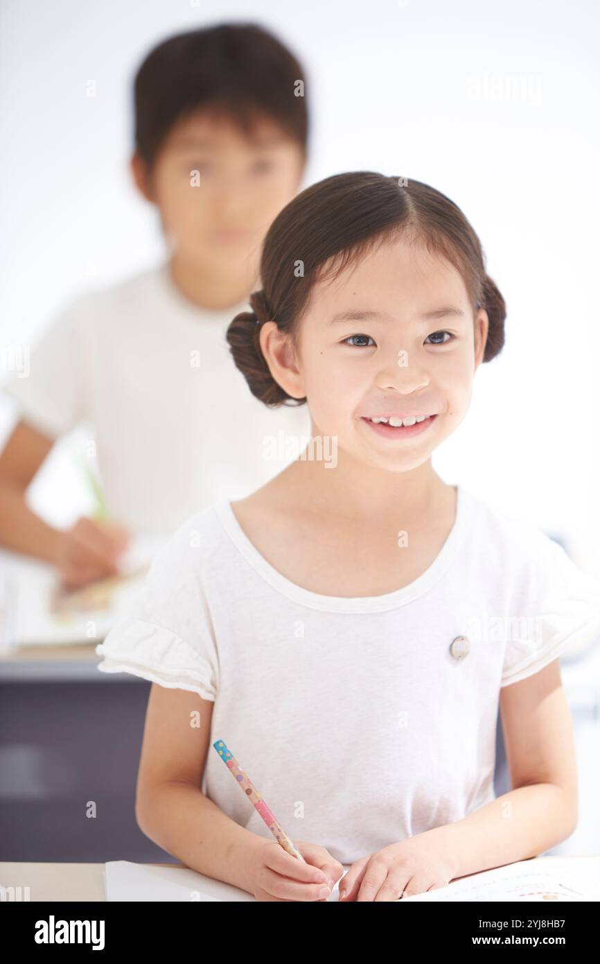 Male and female lower primary school pupils in class Stock Photo - Alamy