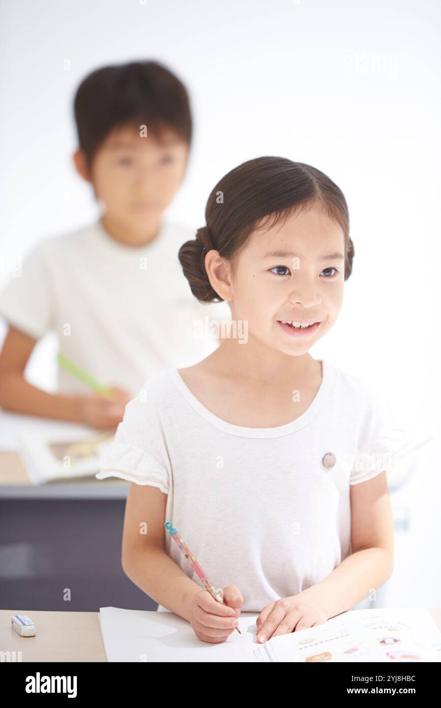 Male and female lower primary school pupils in class Stock Photo - Alamy