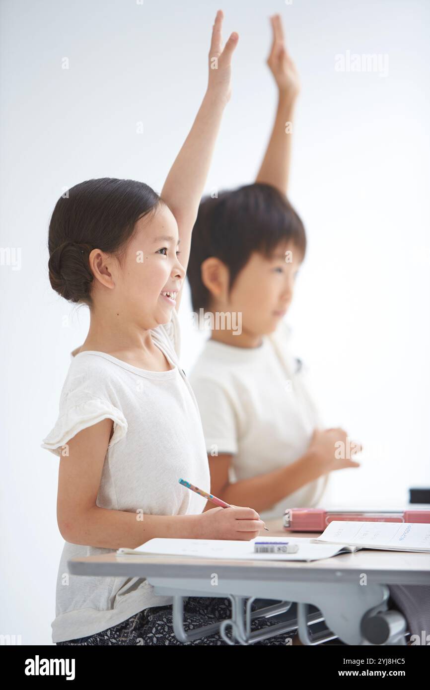 Male and female lower primary school pupils in class Stock Photo - Alamy