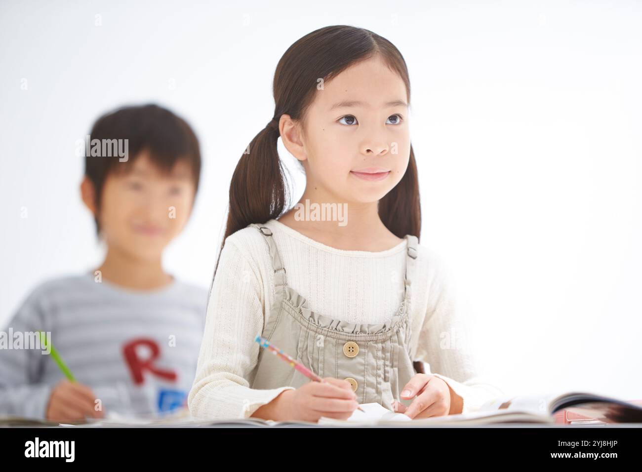 Male and female lower primary school pupils in class Stock Photo - Alamy